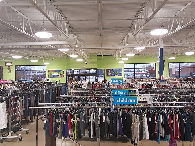 Endless racks stretch toward retail infinity under bright lights and lime green walls—the Narnia of secondhand shopping awaits.