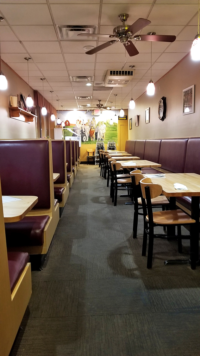 Classic diner comfort with burgundy booths and warm lighting – the stage is set for pancake perfection before you even open the menu.