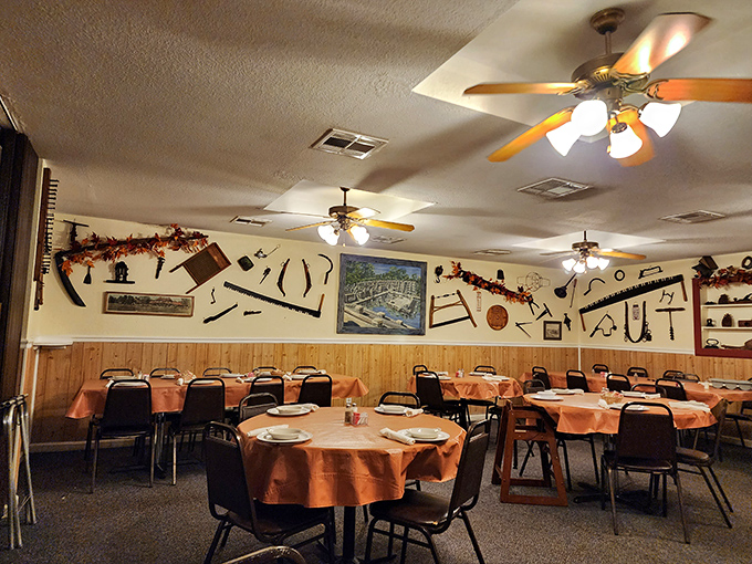 Vintage farm implements adorn walls above orange-clothed tables where strangers become friends. This isn't manufactured nostalgia—it's the real Arkansas deal.