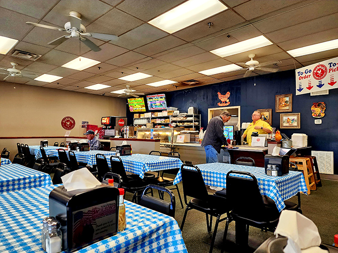 Blue-checked tablecloths and ceiling fans set the stage for comfort food theater—no fancy lighting or pretentious decor, just honest dining at its finest.