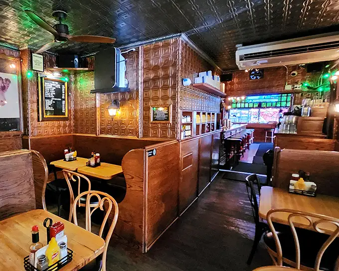Wooden booths and pressed tin ceilings tell stories of decades past. This isn't manufactured nostalgia—it's the real deal, earned one burger at a time.