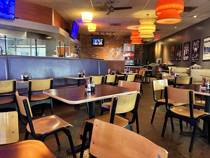 Orange pendant lamps cast a warm glow over wooden tables and blue booths. This isn't fancy dining—it's comfortable eating at its finest.