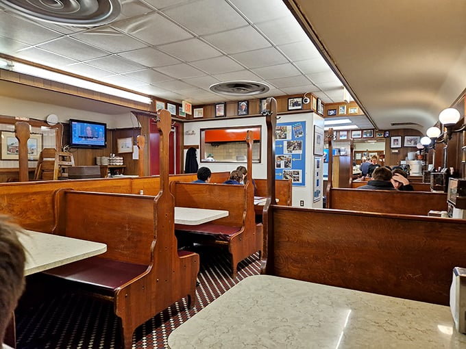 Wooden booths worn smooth by decades of elbows and conversations—this isn't Instagram-engineered nostalgia, it's the real deal that money can't manufacture.