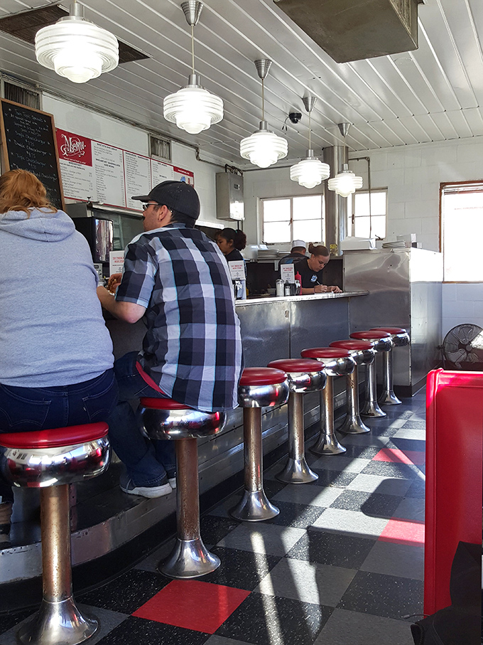 The classic counter seating isn't just nostalgic—it's front-row tickets to the greatest show on earth: watching your burger journey from grill to glory.