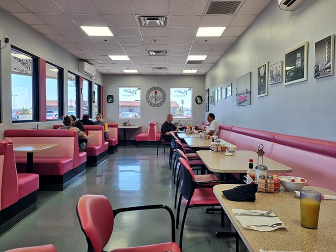 Pink vinyl booths and vintage decor set the stage for culinary time travel. This isn't Instagram-bait design—it's the real deal that's served generations.