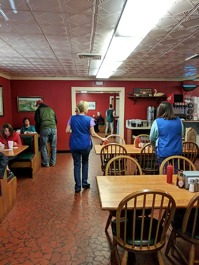 Inside, pressed tin ceilings watch over wooden chairs that have supported generations of barbecue enthusiasts. No designer lighting needed—just pure authenticity.