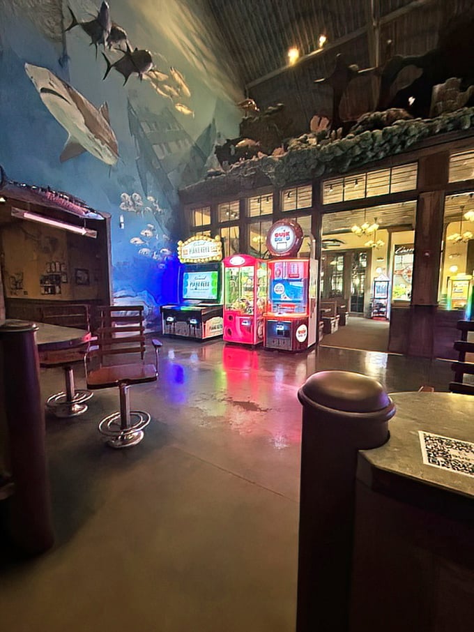 Where arcade games meet the deep blue sea. Those sharks overhead aren't judging your high score—they're just jealous of your gaming skills.