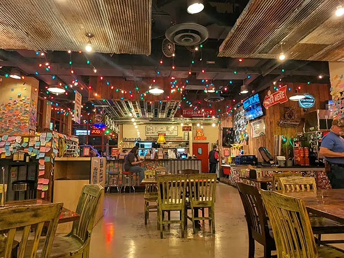 Christmas lights twinkle year-round above wooden tables, creating that "your cool friend's basement" vibe every burger deserves.