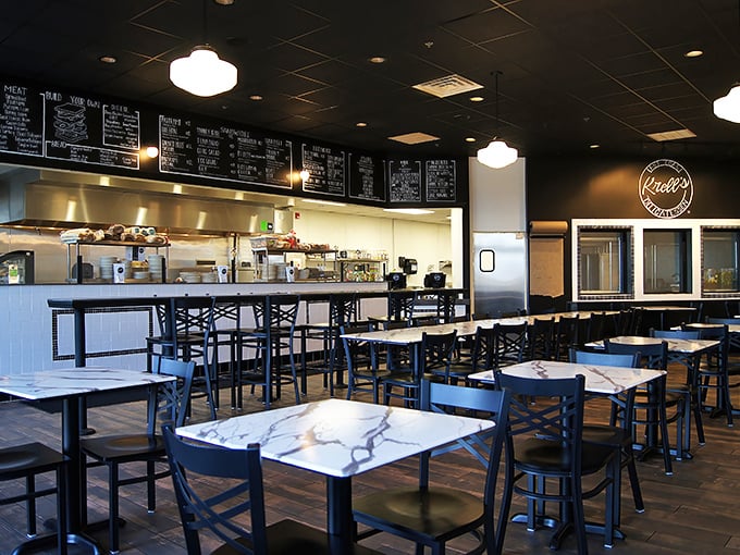 Clean lines, marble tables, and that glorious menu board – this isn't just a restaurant, it's a temple of sandwich worship.