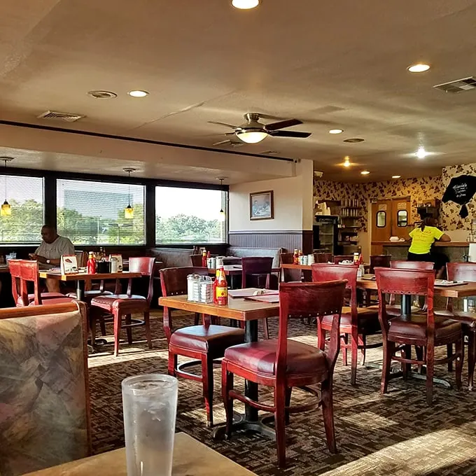 Classic red vinyl chairs and warm wood tables – the universal language of "sit down, relax, and prepare for comfort food that hugs your soul."
