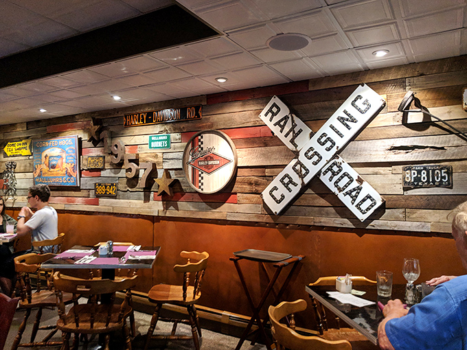 Americana meets appetite inside with rustic wood walls adorned with vintage signs and railroad memorabilia—comfort before your first bite.