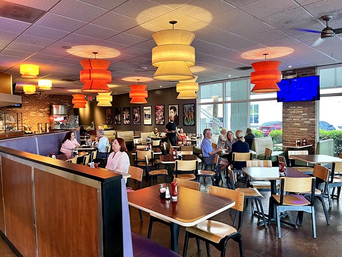 Those orange and yellow pendant lights aren't just illuminating the room—they're setting the stage for the food drama about to unfold on your plate.
