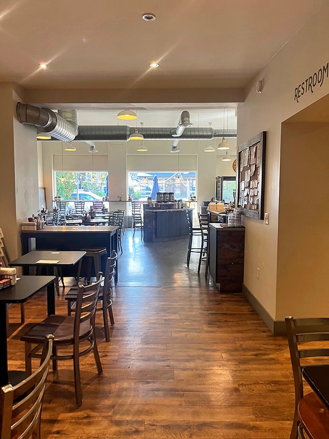 Inside, warm wooden floors meet industrial-chic exposed ductwork, creating a space that says "stay awhile" without saying a word.