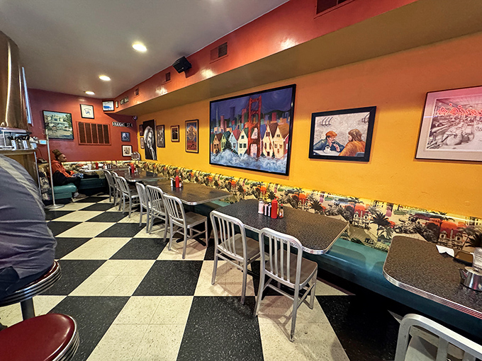 Inside, the classic diner aesthetic shines with checkered floors and warm-toned walls adorned with local art—comfort personified.