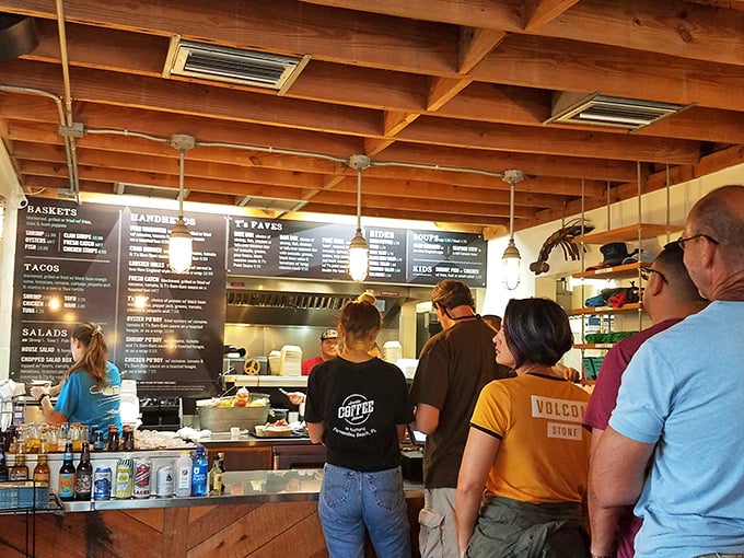 The lunch rush at Timoti's is like watching a delicious choreography—customers eagerly scanning the menu while staff orchestrate a symphony of seafood behind the counter. 