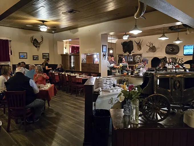 Step inside and time stands still—mounted trophies watch over diners while the warm wood paneling creates the perfect steakhouse atmosphere.
