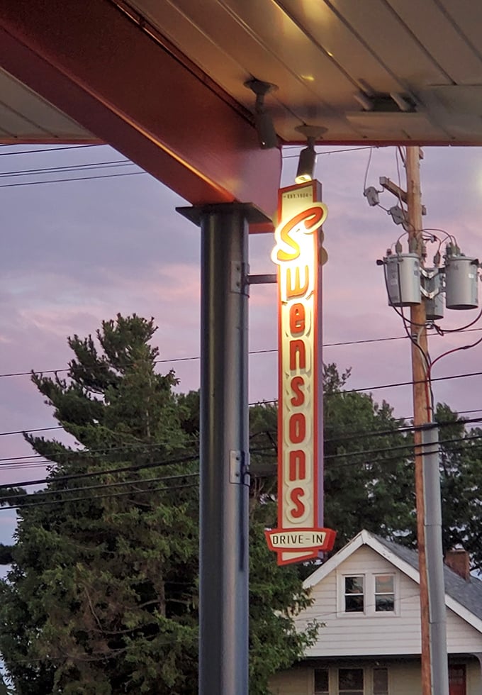As dusk settles over Cleveland, the vertical Swensons sign glows like a neon lighthouse guiding hungry travelers to burger paradise.