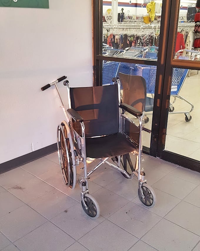 This vintage wheelchair isn't just medical equipment—it's a time capsule on wheels, waiting for its next chapter while shoppers hunt for treasures beyond.