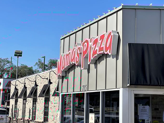 Mama's Pizza sign glows with promise against the sky. Some traditions are worth preserving! 