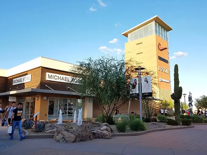 Michael Kors meets desert chic at Phoenix Premium Outlets, where cacti stand guard over designer bags like fashionable sentinels.