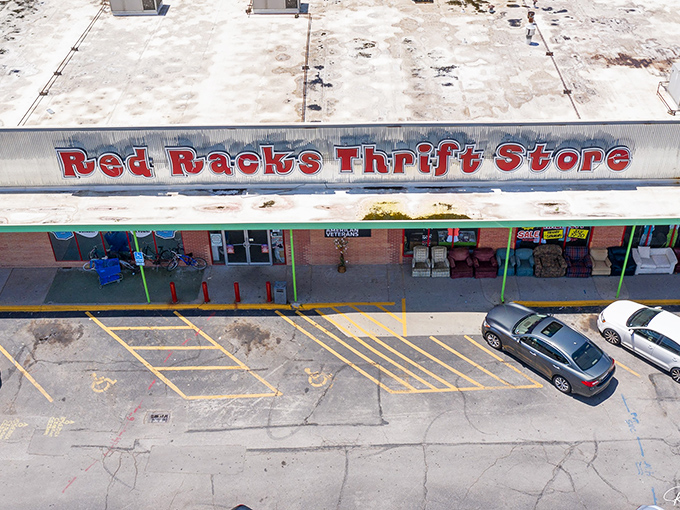 Red Racks' bold signage stands out against the sky. This thrift paradise helps veterans while helping your wallet!