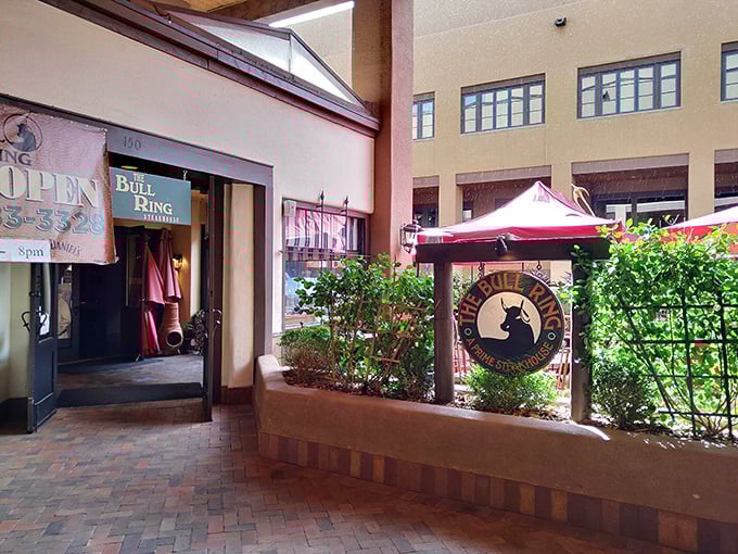 The Bull Ring's entrance promises culinary drama ahead. That brick walkway has guided countless hungry patrons toward steak nirvana.