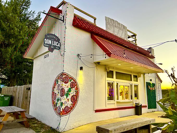 That hand-painted pizza mural isn't just decoration—it's a preview of the cheesy masterpiece you're about to experience!