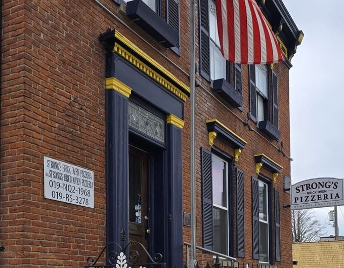 That classic brick façade isn't just for show—it houses pizza magic that would make any Italian nonna proud.