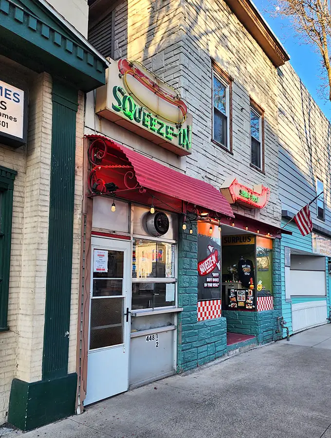 Turquoise walls, checkered tiles, and hot dogs that snap with each bite—The Squeeze-In is a delicious blast from the past.