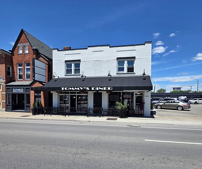 Classic white brick and black awnings – Tommy's Diner doesn't just serve nostalgia, it IS nostalgia in architectural form.