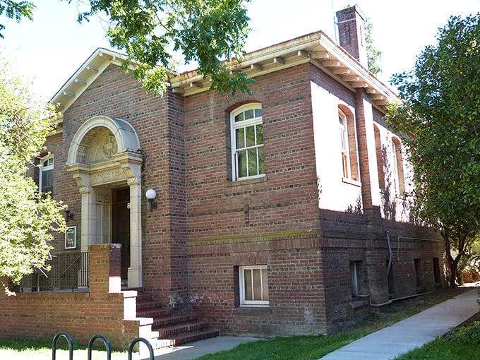 The brick Carnegie Library building represents an era when communities built temples to knowledge rather than shopping malls.