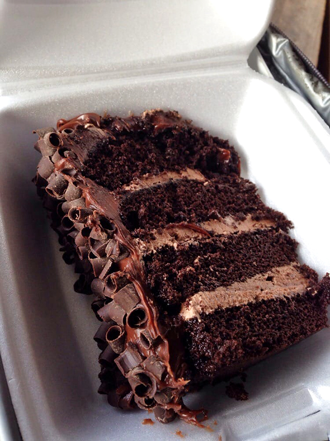 This chocolate layer cake doesn't just have layers; it tells a story with each decadent tier, chocolate shavings standing guard over the richness within.