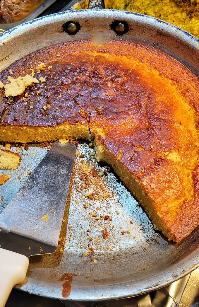 This cornbread doesn't just sit on the plate—it commands attention with its golden-brown crust and moist interior. Grandmothers everywhere would approve.