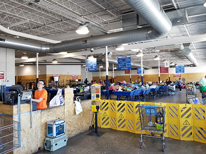 Inside awaits the organized chaos of bargain hunting—exposed ductwork above and treasure-filled bins below create the perfect backdrop for retail archaeology.