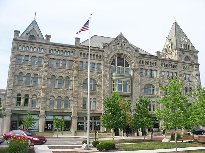 Fort Piqua Hotel stands like a limestone sentinel, guarding memories of an era when travel meant trunks and telegrams.
