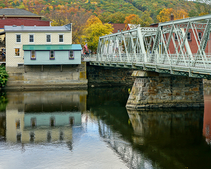 Not just any bridge—this iron sentinel has connected the two halves of Shelburne Falls through countless New England seasons.