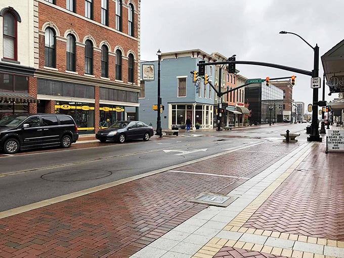 Rain-slicked streets reflect Muncie's historic architecture, where small-town charm meets big-city amenities without the big-city price tag.