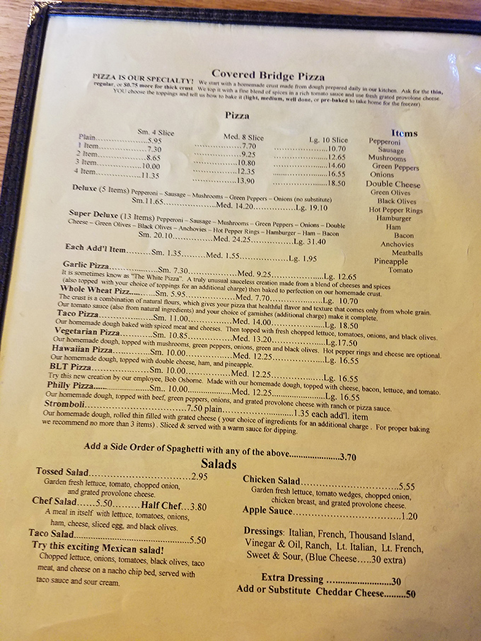 A menu that reads like a love letter to pizza possibilities. The hardest bridge to cross might be deciding between the Taco Pizza and Stromboli.