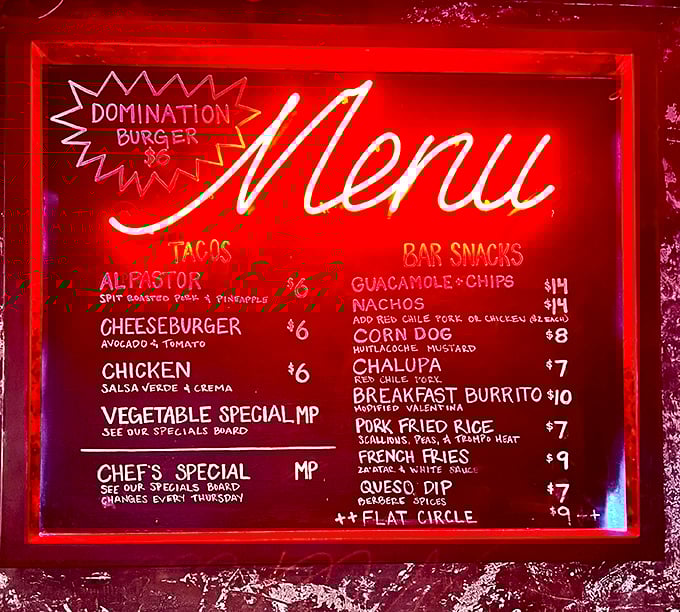 Menu magic in neon red. The "Domination Burger" might sound intimidating, but it's the al pastor tacos that truly rule this roost.