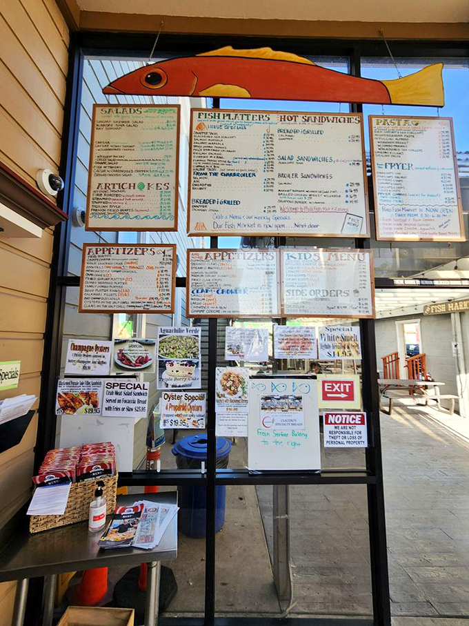 The wall of menus at Phil's is like the seafood version of the Rosetta Stone – overwhelming at first glance, but deciphering it leads to culinary treasures worth the effort.
