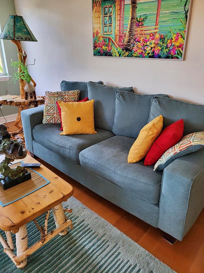This isn't just any blue sofa—it's your future reading nook, complete with vibrant pillows that pop like a South Beach sunset.