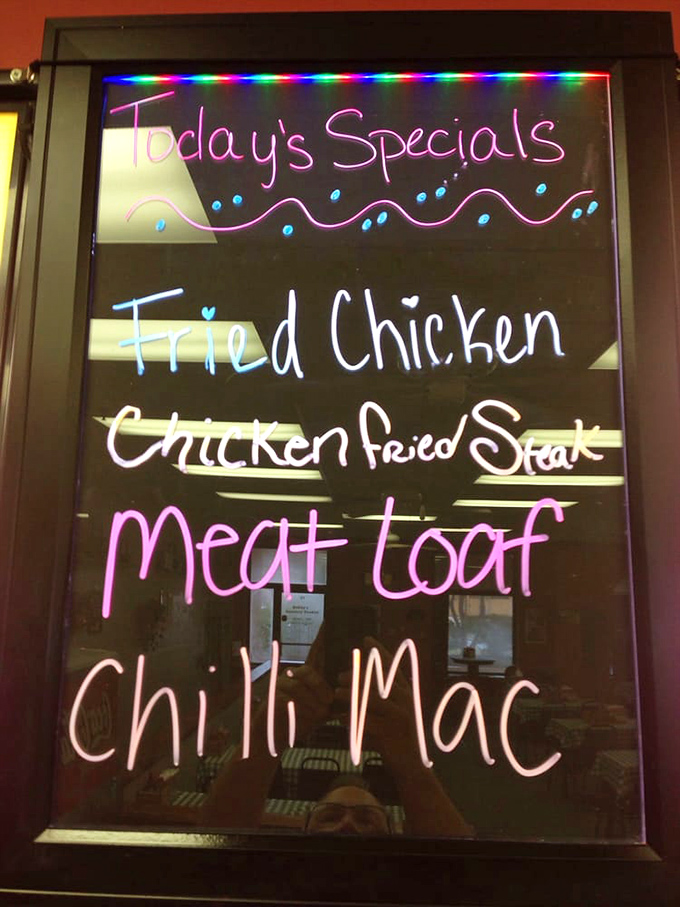 The illuminated specials board glows like a beacon of hope for the hungry. Meatloaf, fried chicken, and chili mac—the holy trinity of comfort.