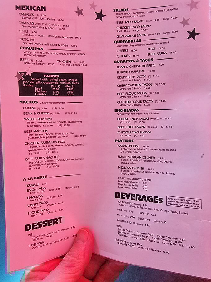 A menu that reads like a love letter to Texas comfort food – the pink paper might be faded, but those flavor combinations are timeless.