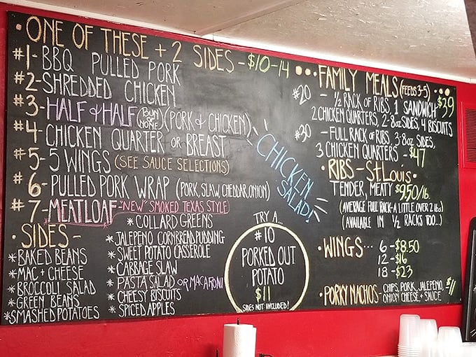 This chalkboard menu isn't just a list—it's a roadmap to happiness. The "Porked Out Potato" alone deserves its own zip code.