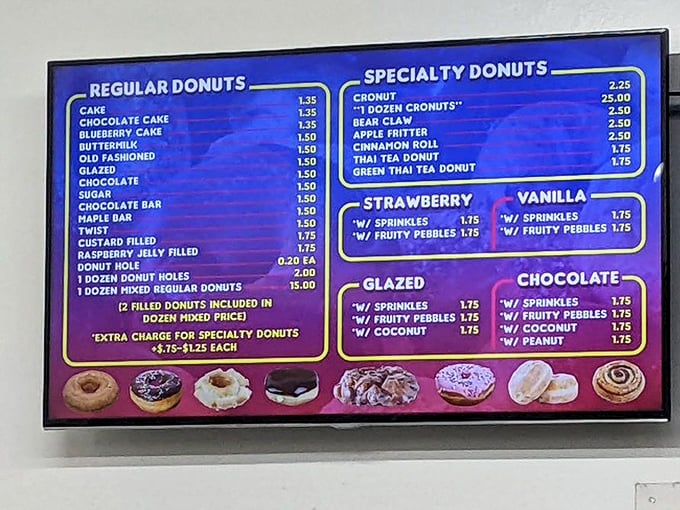 The menu board glows like a blue beacon of hope for the sugar-deprived, offering everything from classic glazed to exotic Thai tea creations.
