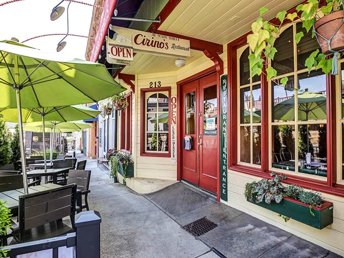 Cirino's vibrant red facade and lime-green umbrellas aren't just inviting – they're practically shouting "Get in here and eat something delicious already!"