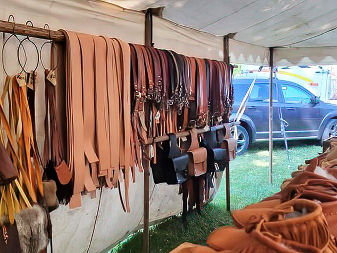 Leather craftsmanship on full display – belts, bags, and wallets hanging like an artisan's color wheel. That perfect belt you've been searching for your whole life? It's probably here.