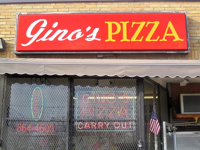 Gino's neon glow promises pizza salvation to weary travelers. The simple exterior hides extraordinary flavors within.