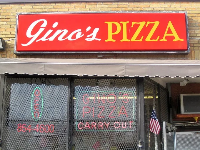 Gino's neon glow promises pizza salvation to weary travelers. The simple exterior hides extraordinary flavors within.