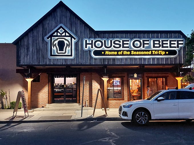 House of Beef's rustic wooden facade and illuminated sign – like a lighthouse guiding meat lovers to safe harbor.
